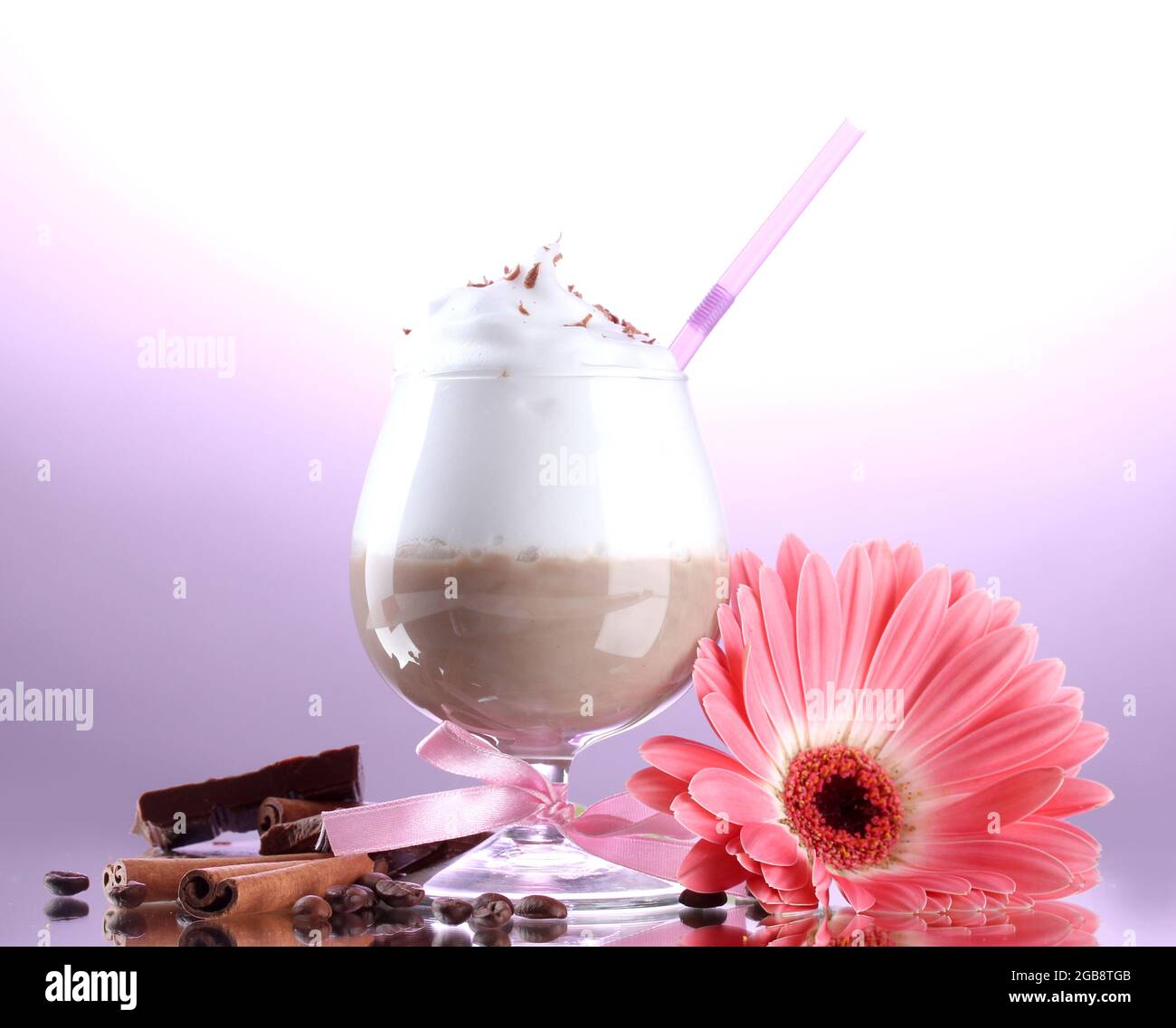 glass of coffee cocktail and gerbera flower on purple background Stock ...