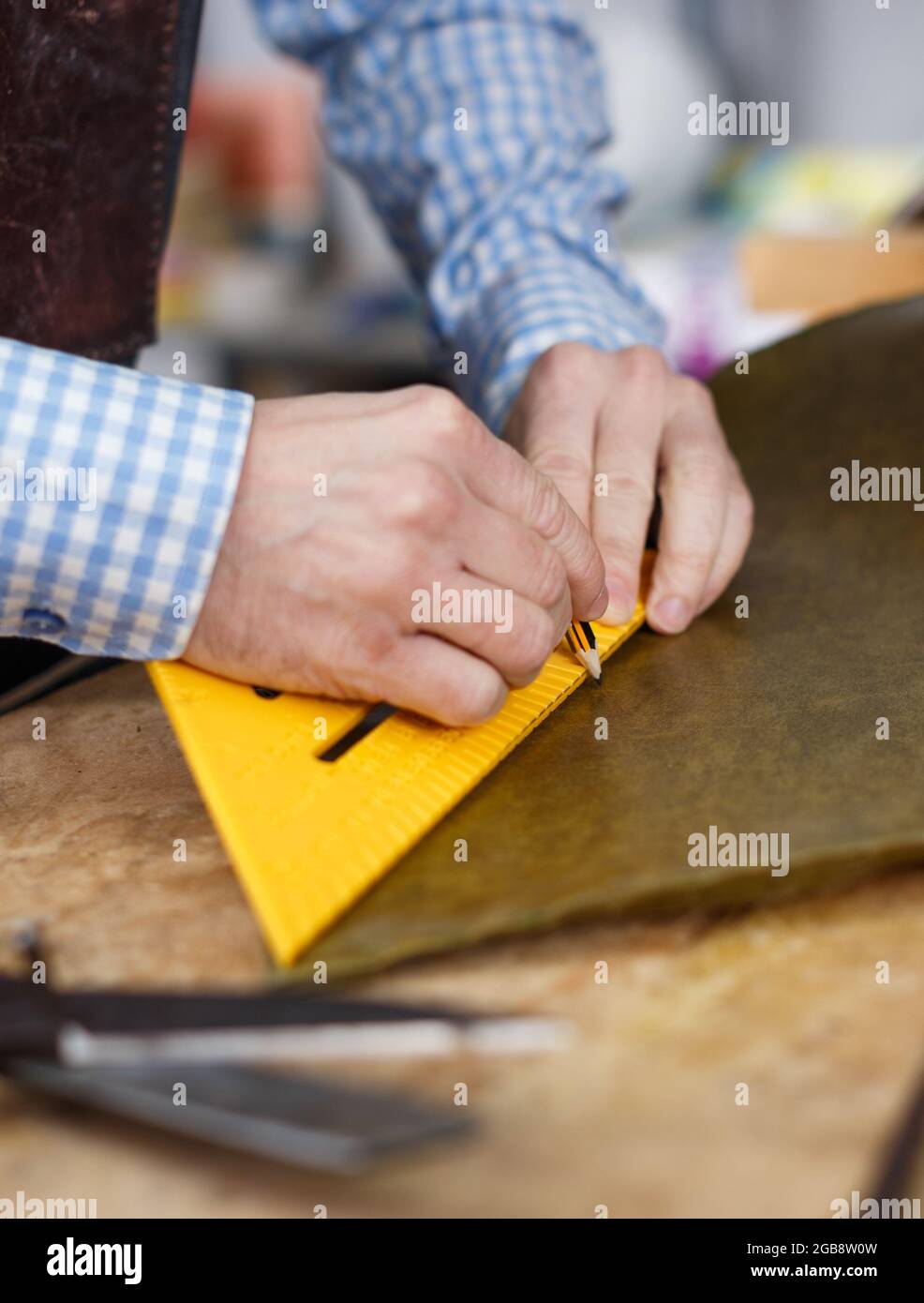 Hands working with ruler and leather Stock Photo - Alamy
