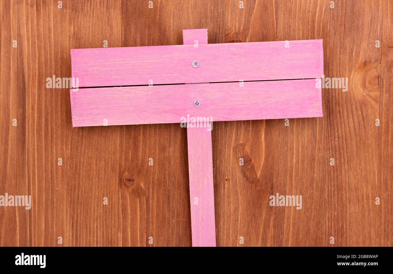 Color wooden sign board on wooden background Stock Photo - Alamy