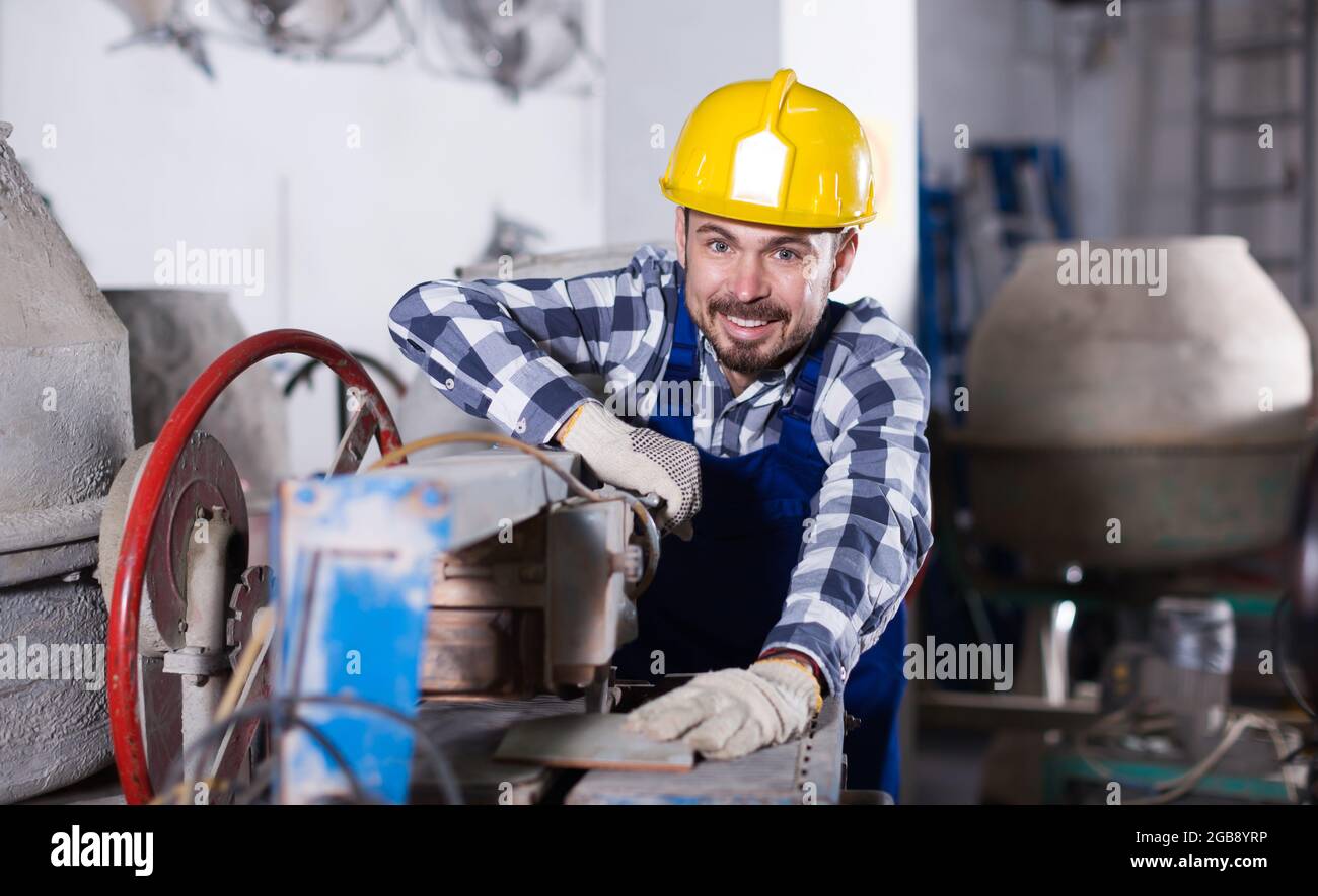 Adult male worker cutting tile with disk saw Stock Photo - Alamy