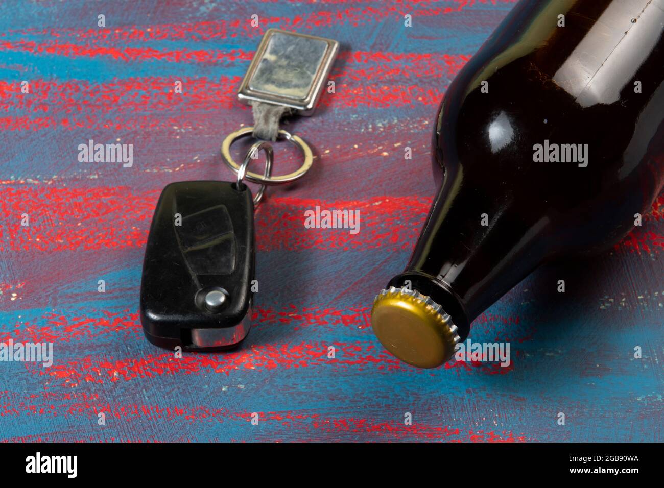 alcohol abuse and danger in car driving symbolized by key and bottle ...