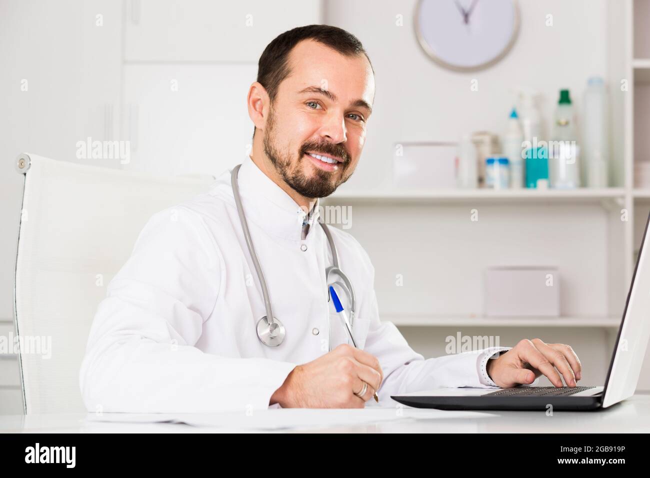 Positive male doctor ready to receive clients Stock Photo - Alamy