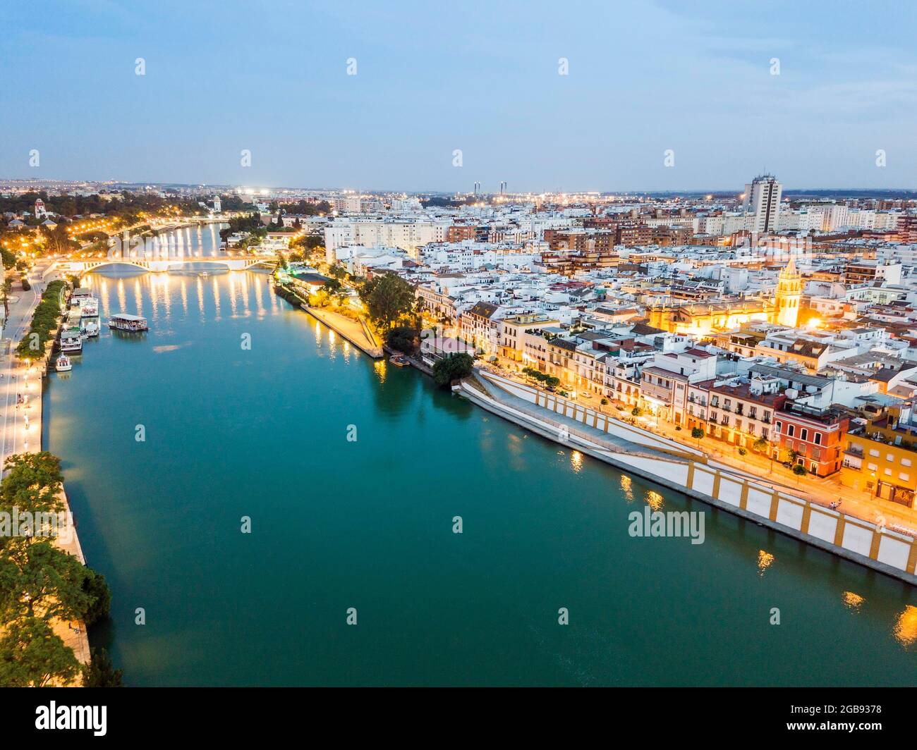 Aerial view of historic part with the river in Seville by the evening ...