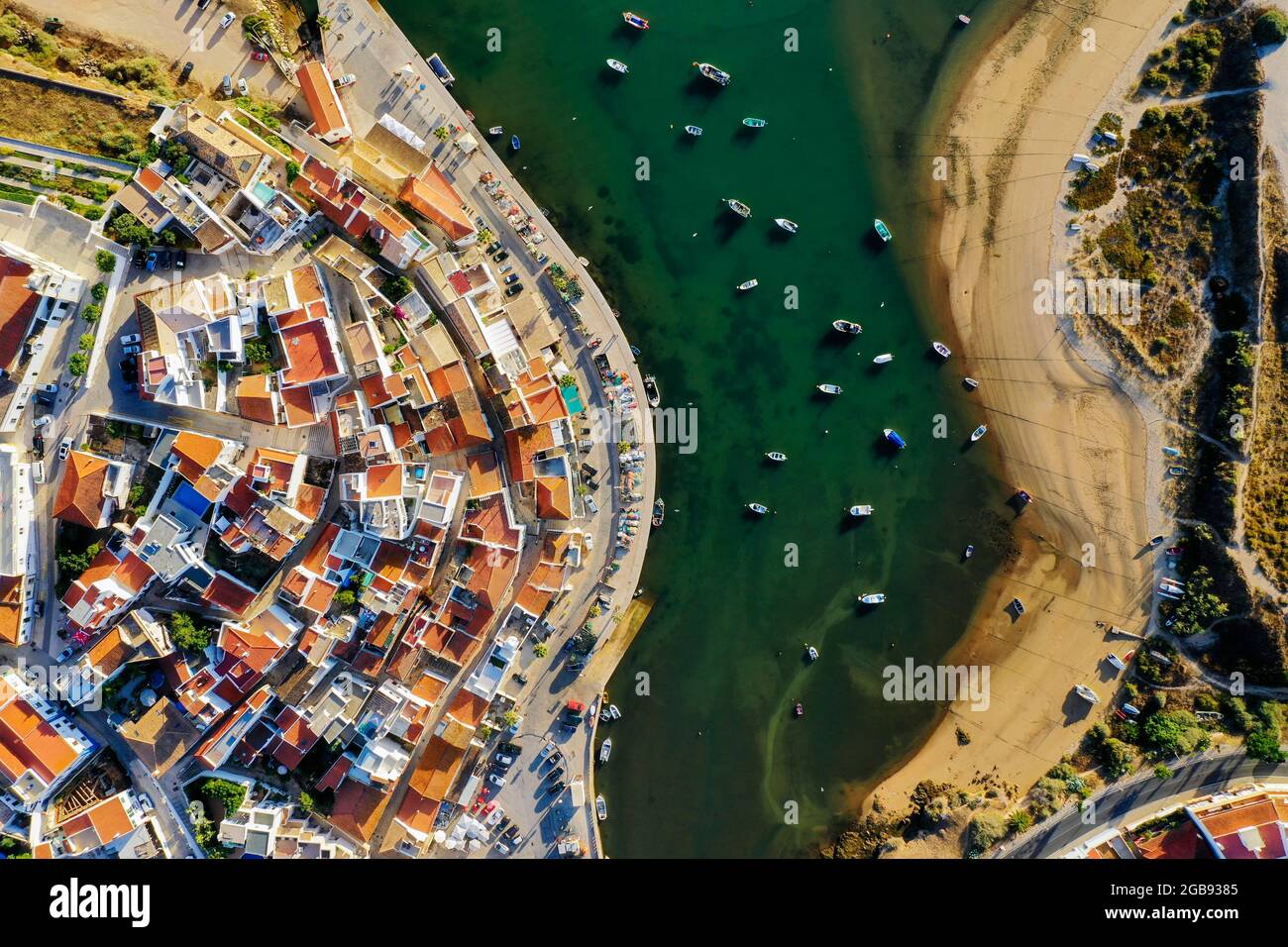 Aerial cityscape of white washed Ferragudo by Arade River, Algarve ...