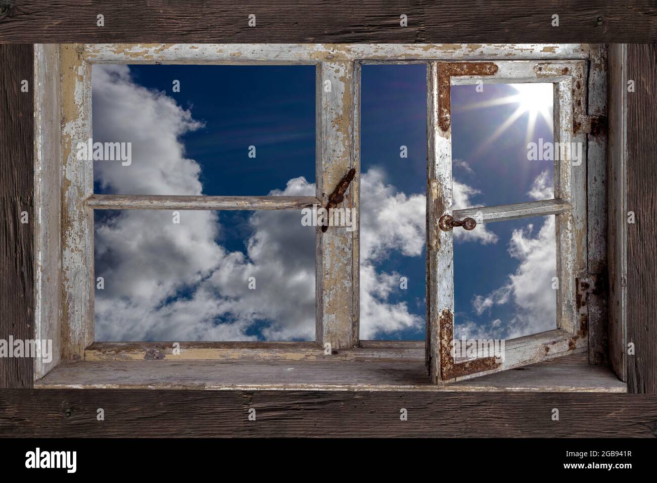 View from a rustic wooden window into the cloudy sky, Composing ...