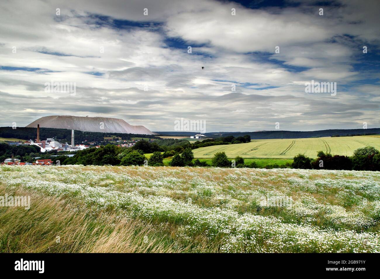View over fields to village and overburden salt dump, potash mining ...