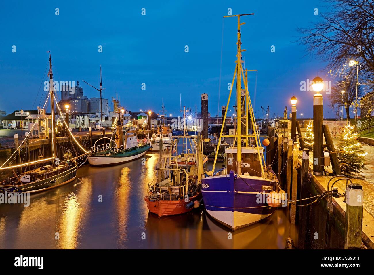 Historic harbour at Christmas time in the evening, Buesum, Dithmarschen ...