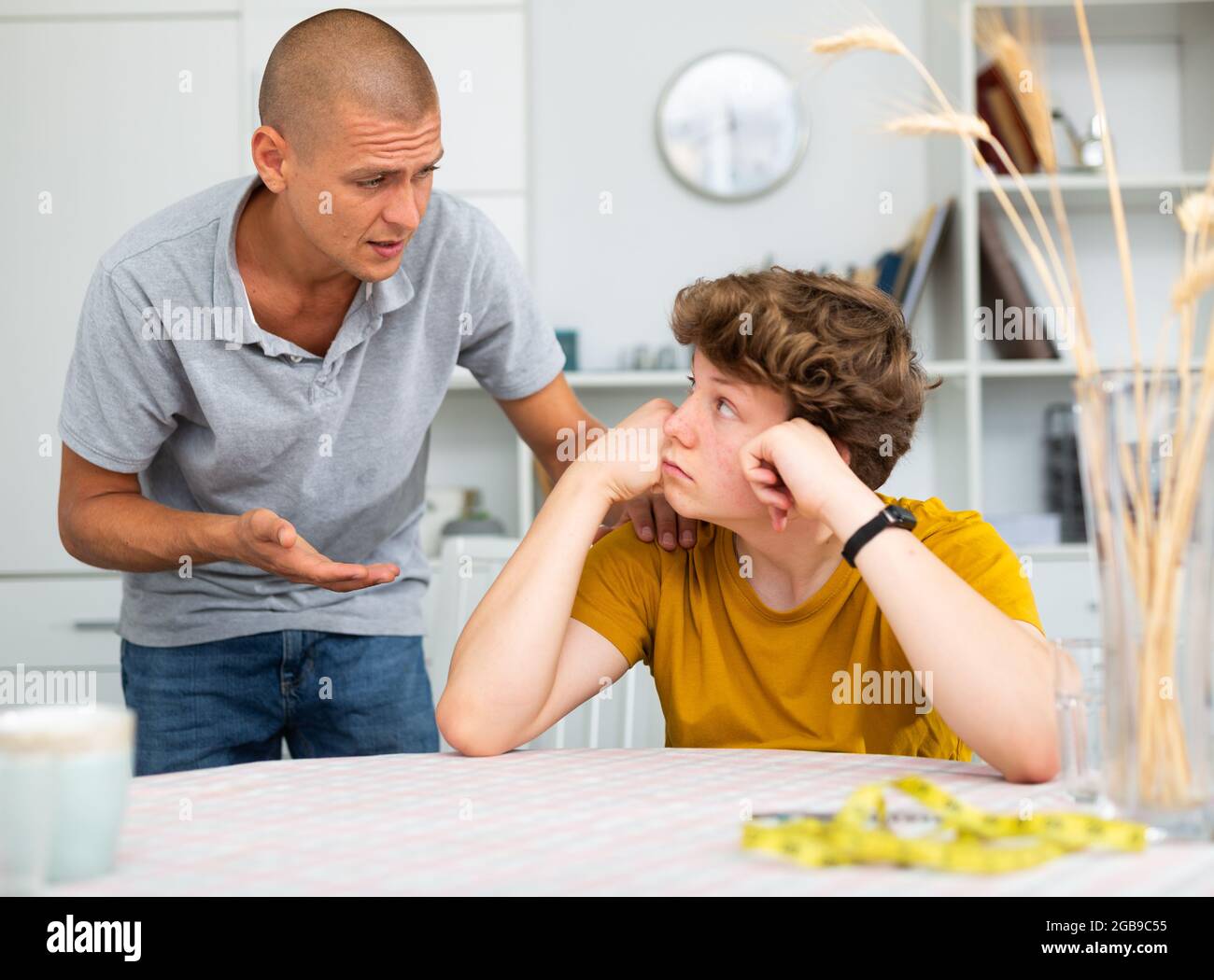 Teenager feeling upset and his father comforting him Stock Photo - Alamy