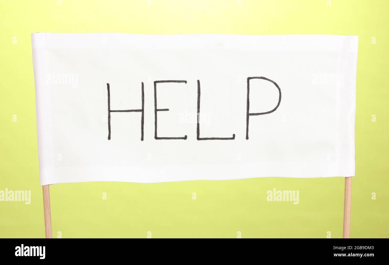 Help written on white cloth on green background Stock Photo - Alamy