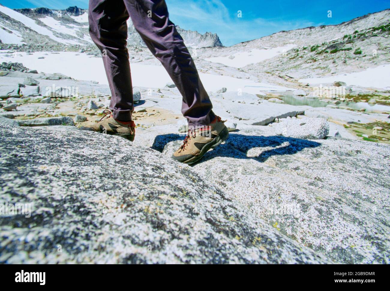 A mans feet and legs as he hikes in the Central cascades Range in the ...