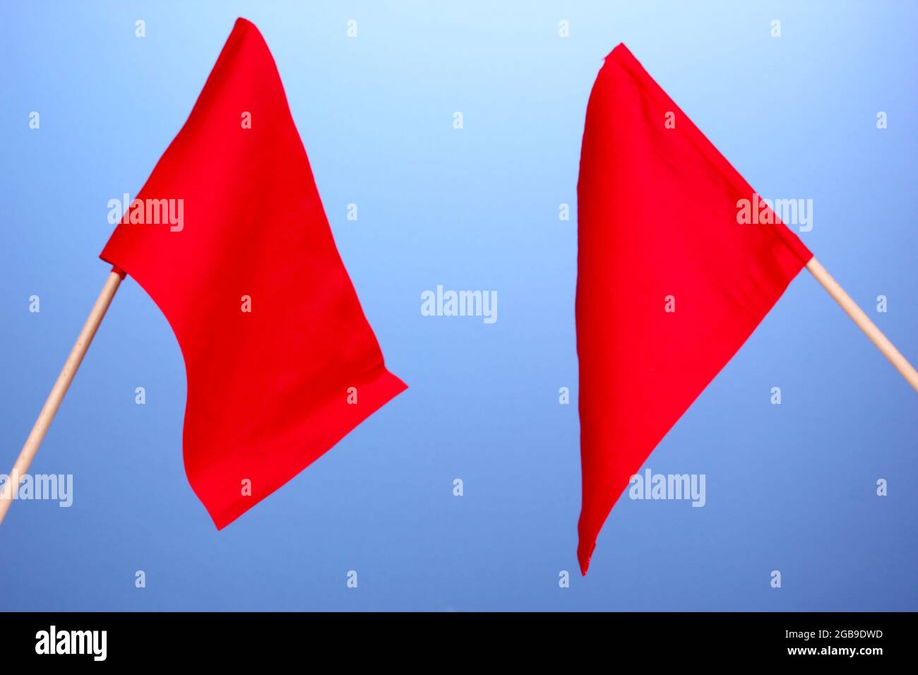 Red signal flags on blue background Stock Photo - Alamy
