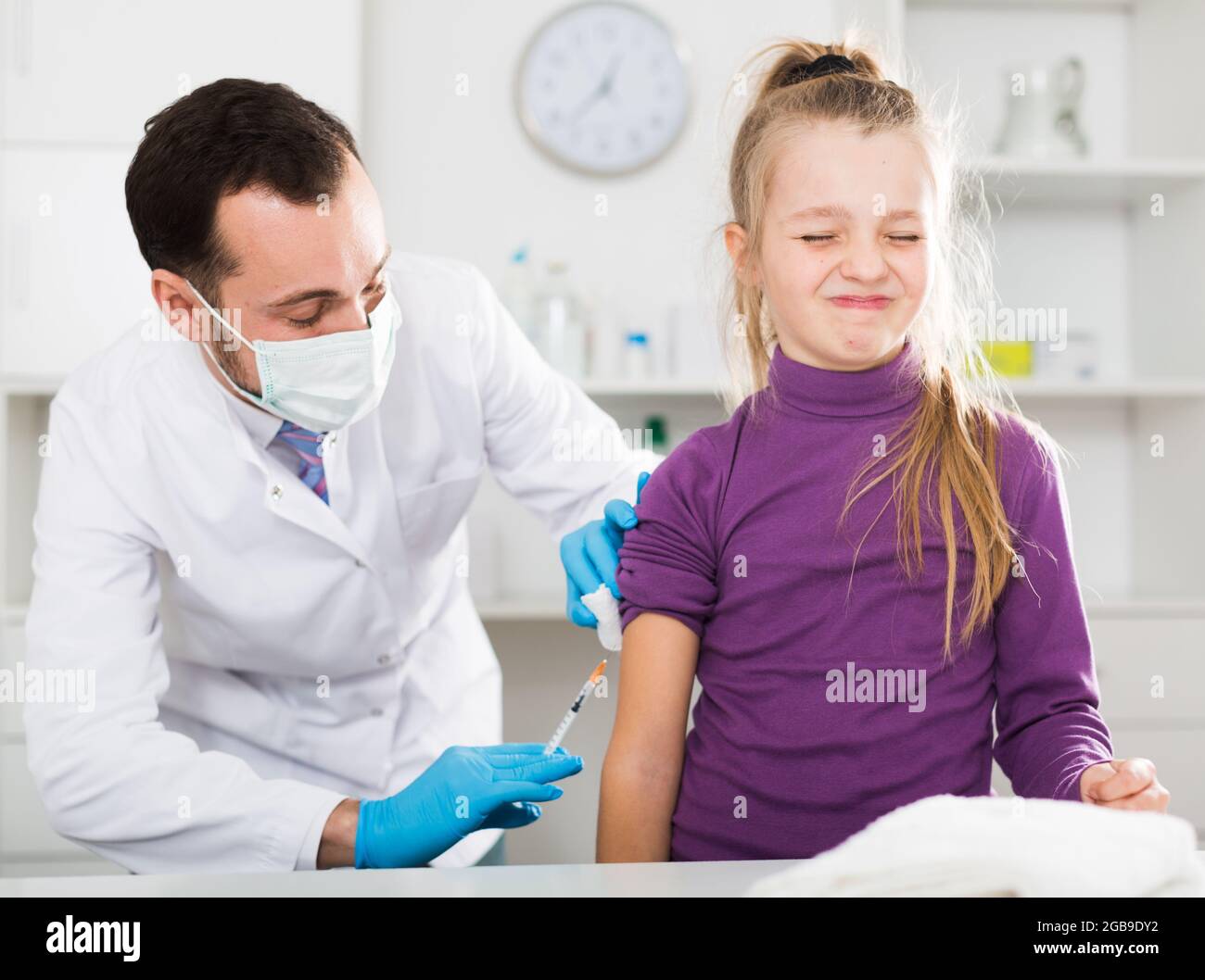 Male doctor injecting little patient Stock Photo - Alamy