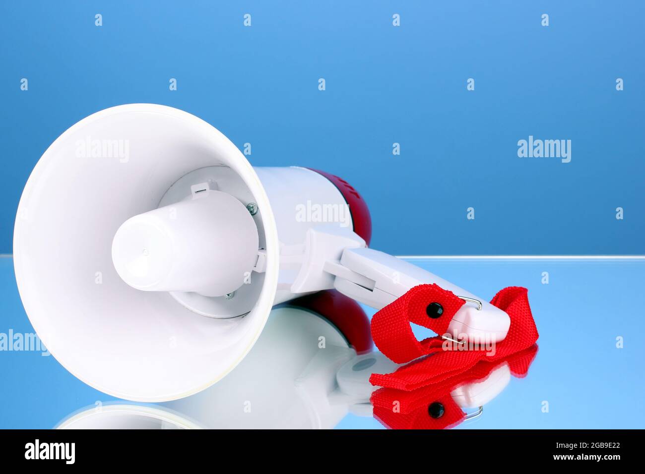 red and white megaphone on blue background Stock Photo - Alamy