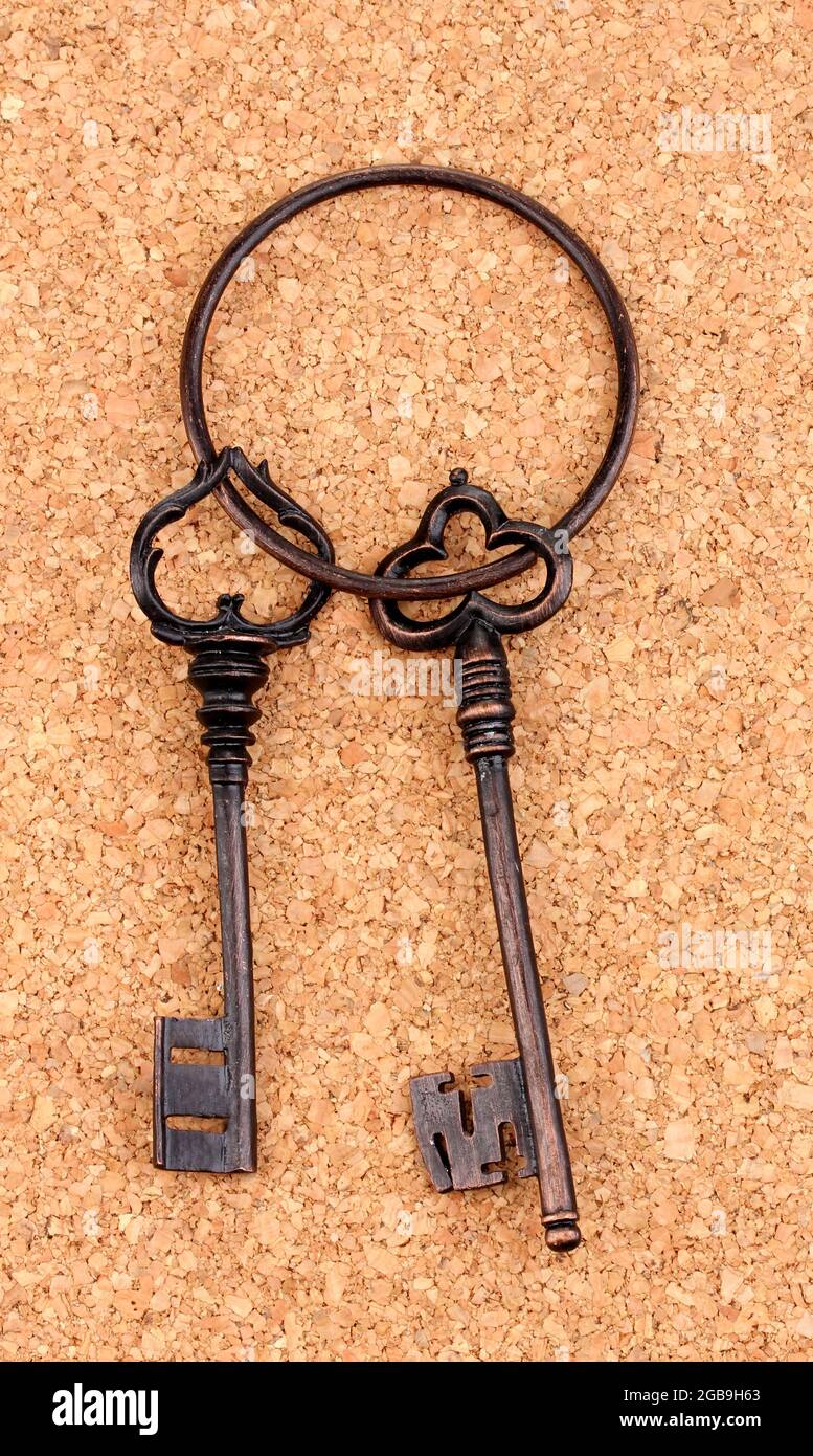 a bunch of antique keys on cork background Stock Photo - Alamy