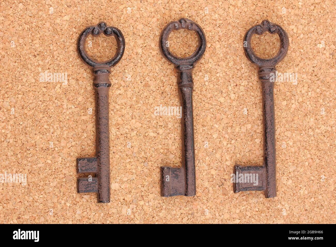 a bunch of antique keys on cork background Stock Photo - Alamy