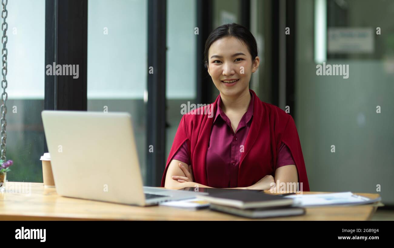 Portrait of Asian female accounting manager smile and looks to camera ...