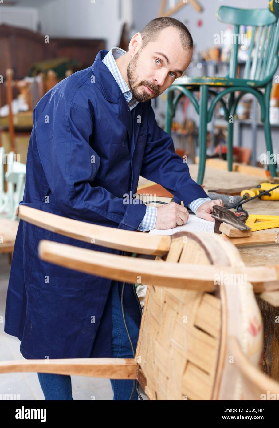 Carpenter repairing antique chair Stock Photo - Alamy