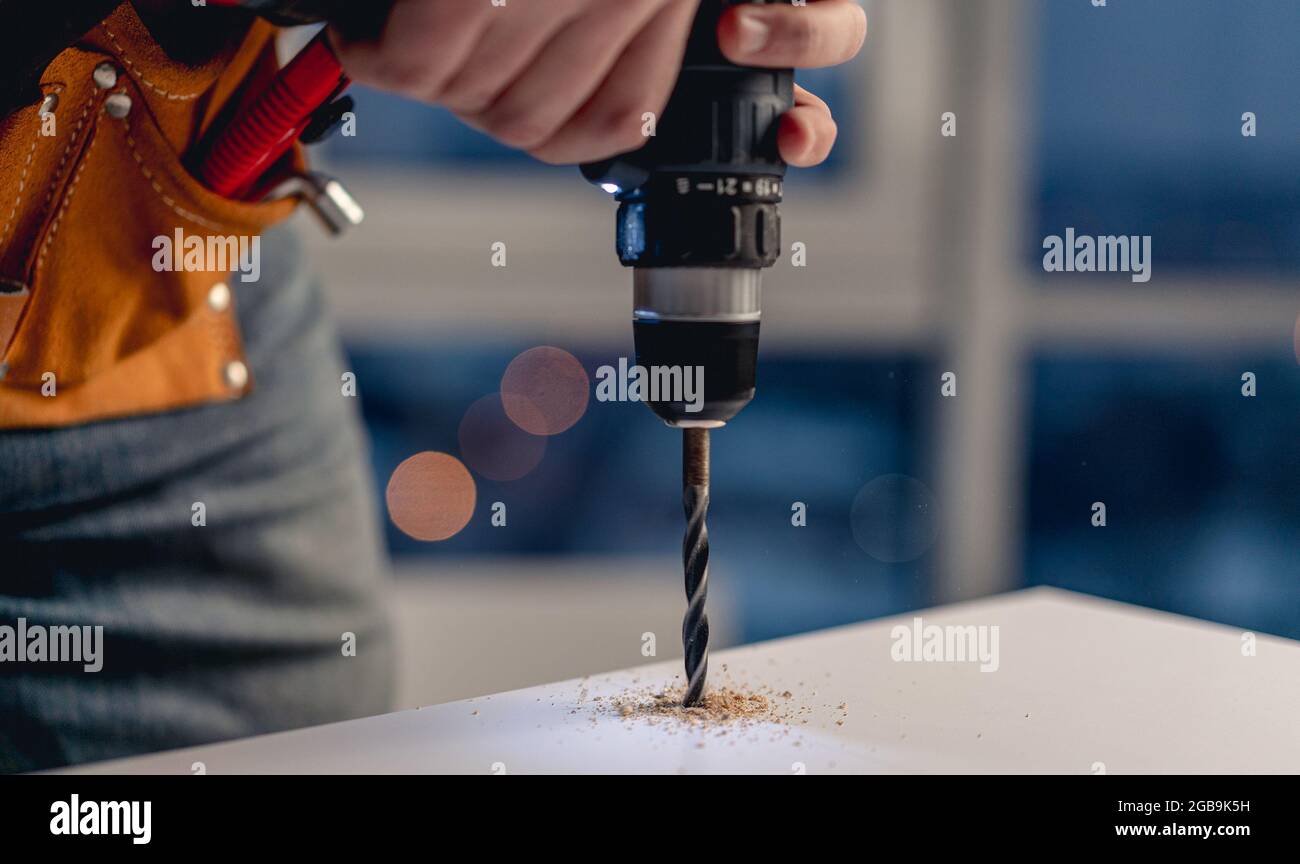 Man working with electric screwdriver and screws during process of ...