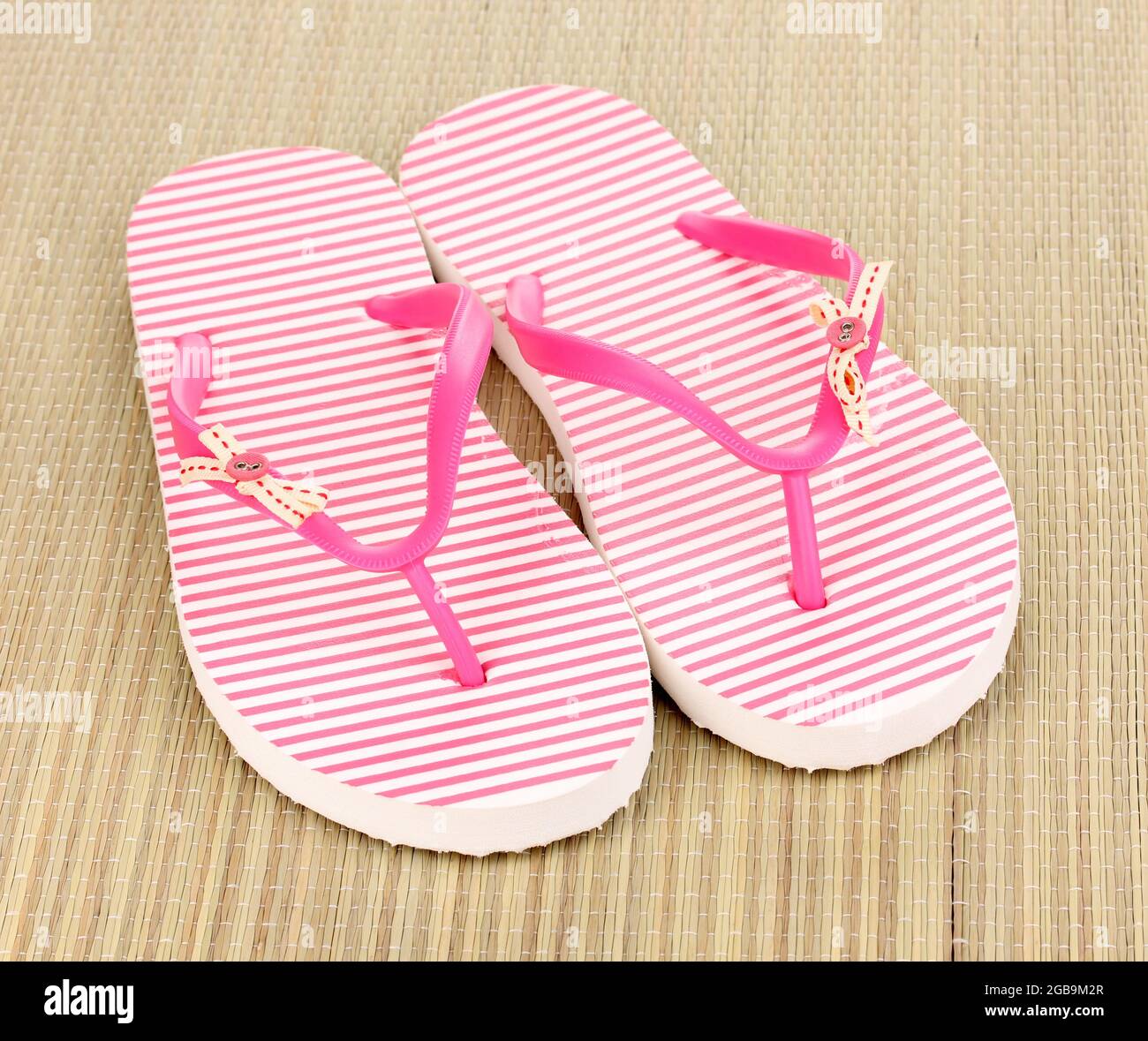 Pink beach slippers on mat Stock Photo - Alamy