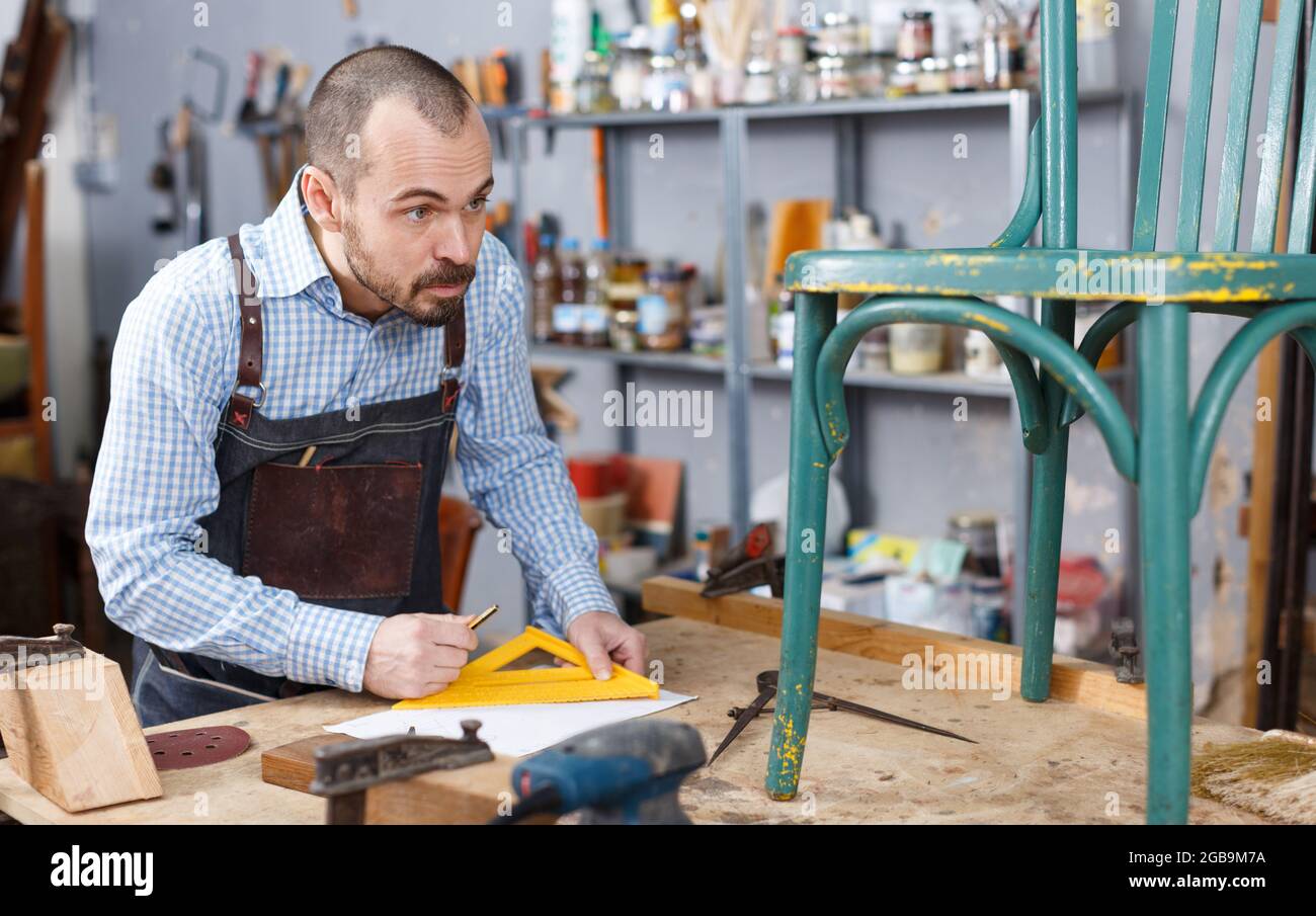 Carpenter measuring wooden plank Stock Photo - Alamy