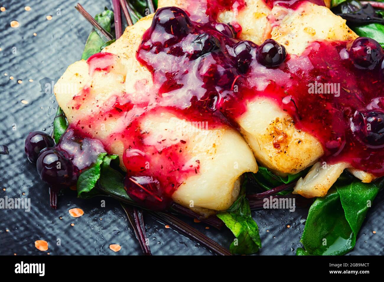 Delicious baked fish with berry sauce. Stewed pangasius with ...