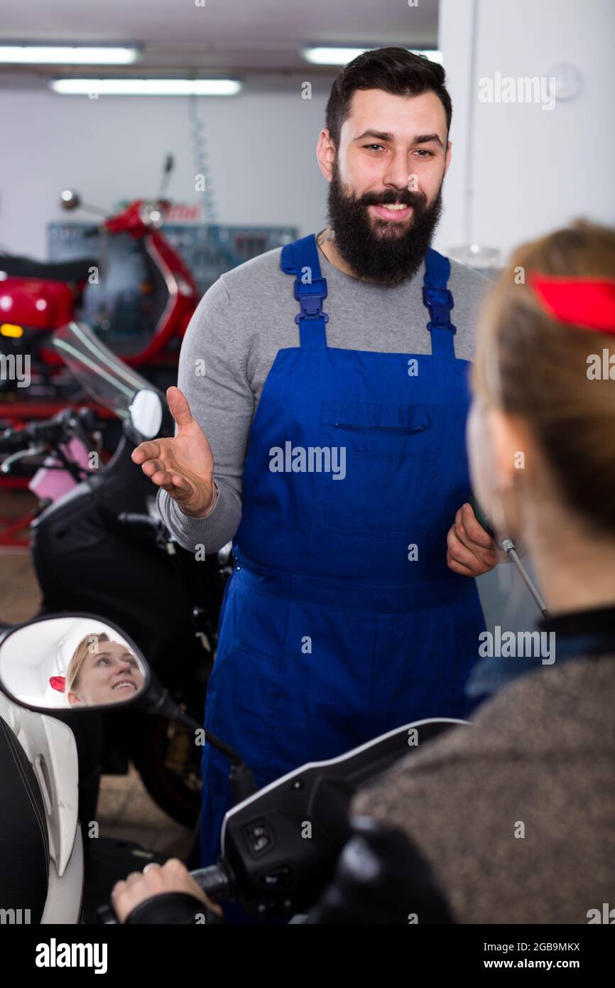 Worker helping woman Stock Photo - Alamy
