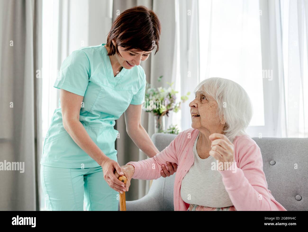Female nurse caring elderly woman hi-res stock photography and images ...