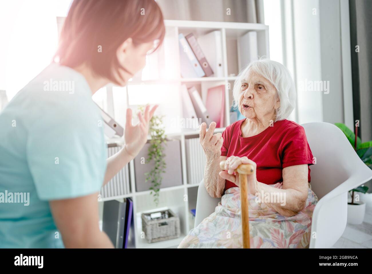 Elderly woman and nurse Stock Photo - Alamy