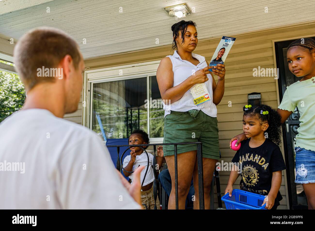 Canvas volunteer, Eric Young, talks to Tenisha Senter, a mother of six ...