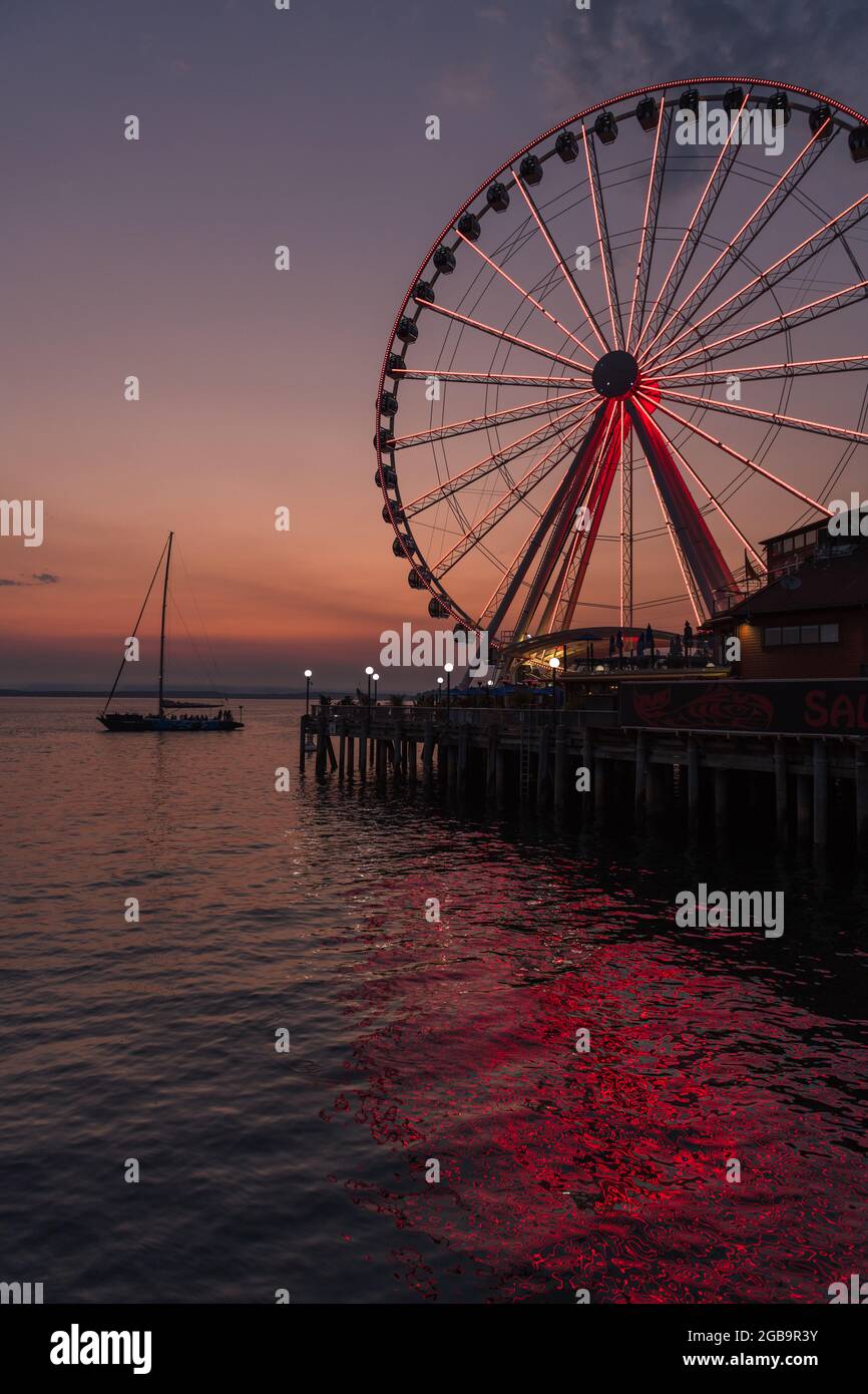 Seattle, USA. 2 Aug, 2021. A smokey sunset over Elliott Bay and pier 57 ...