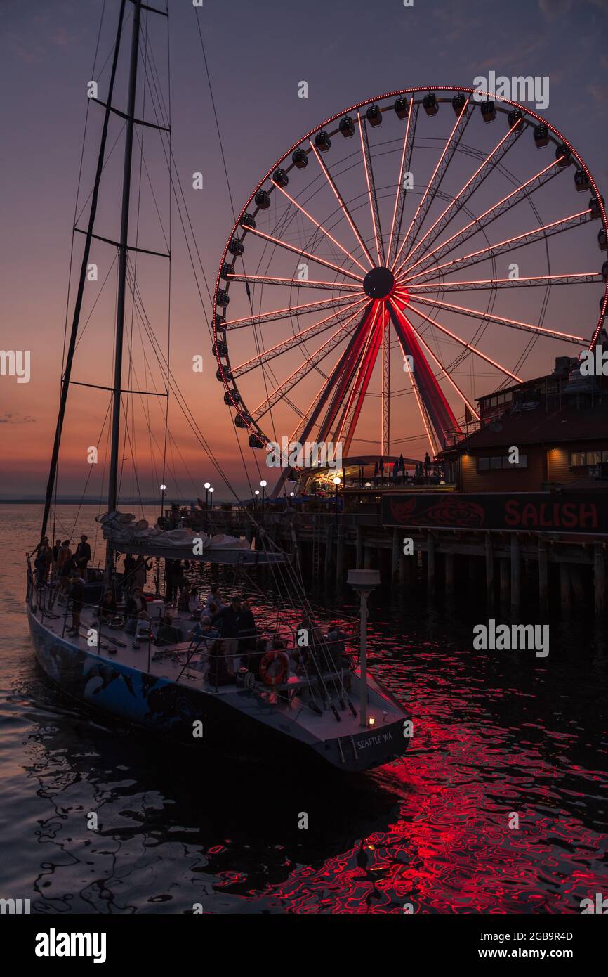 Seattle, USA. 2 Aug, 2021. A smokey sunset over Elliott Bay and pier 57 ...