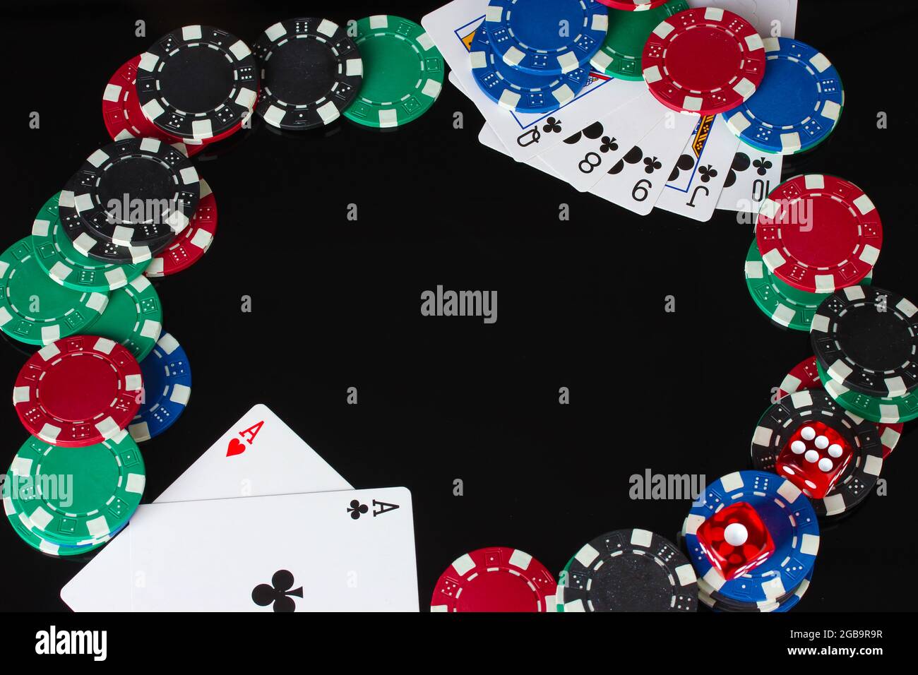 frame made of playing cards and poker chips on black background close ...