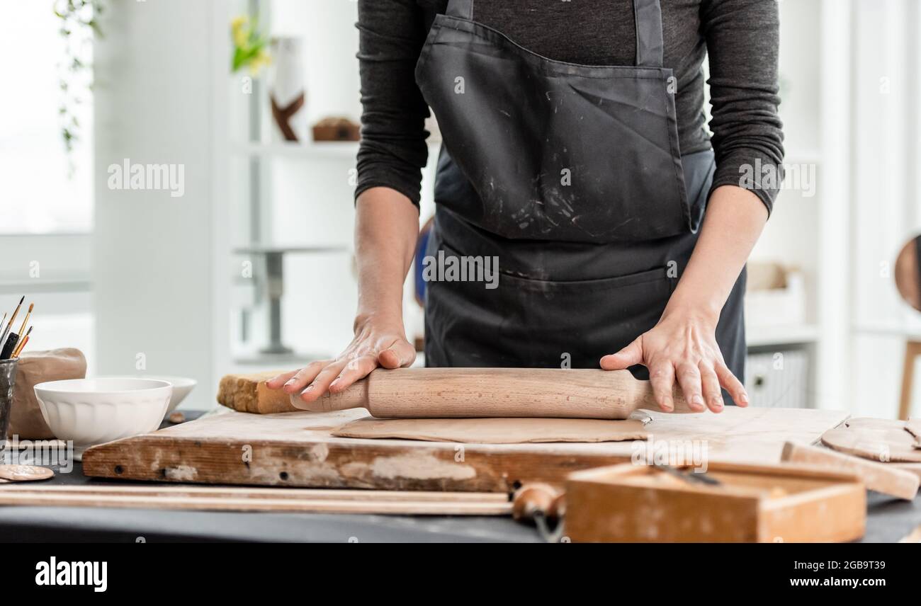 Man forming mold from pottery clay at workshop Stock Photo - Alamy