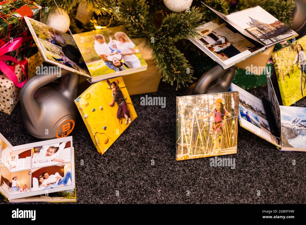 photobook, album and weights for sports near the Christmas tree as a ...
