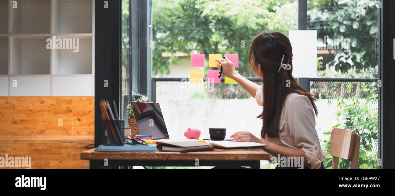 Business attractive young asian woman write notes on sticky note paper ...