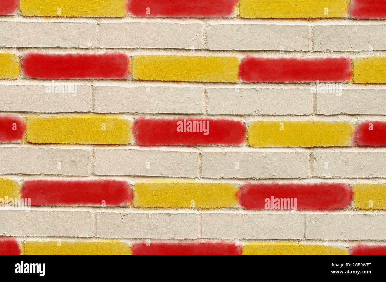 Brick wall, with red and yellow painted bricks Stock Photo - Alamy