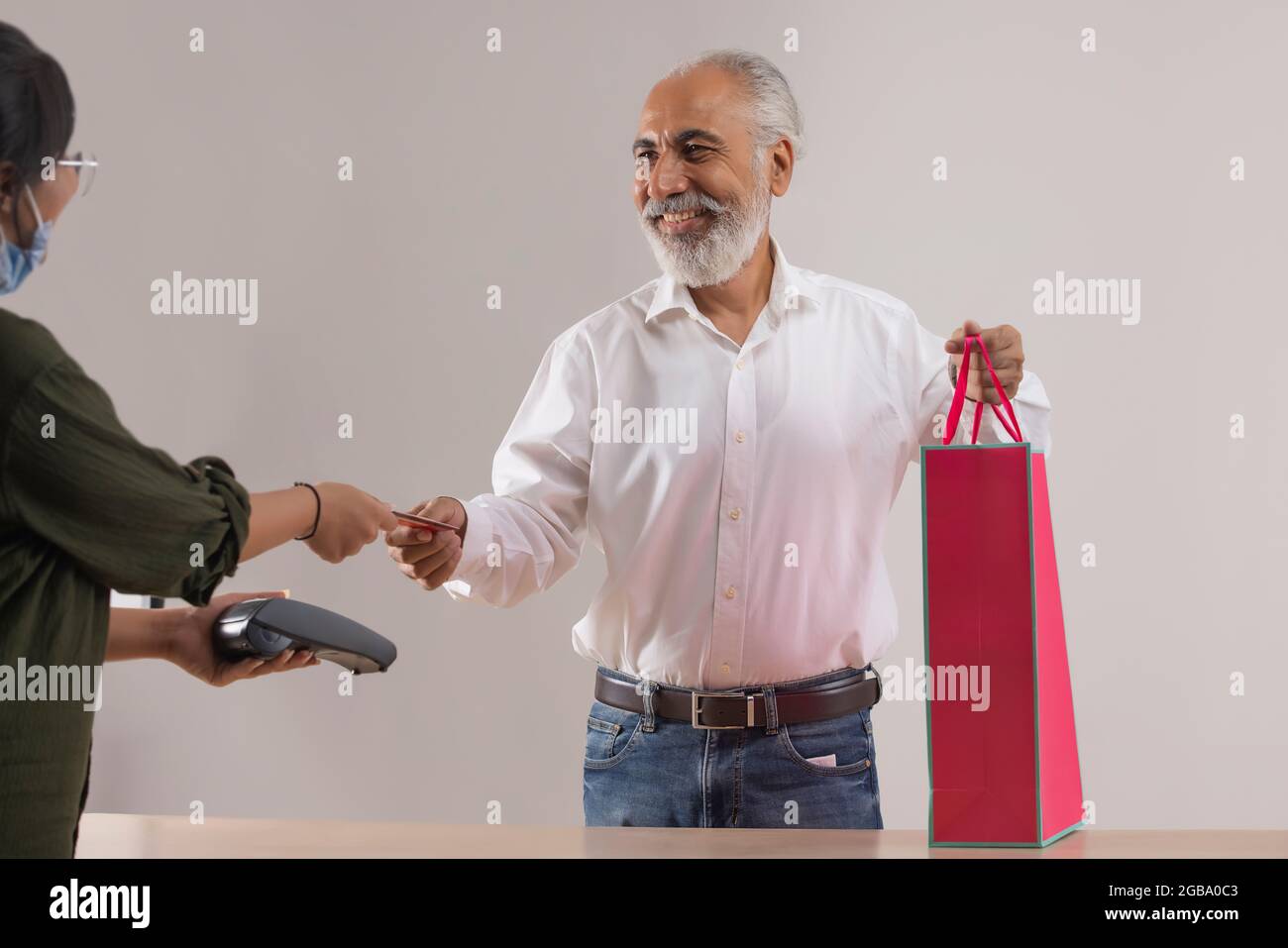AN OLD MAN USING DEBIT CARD TO SHOP Stock Photo - Alamy