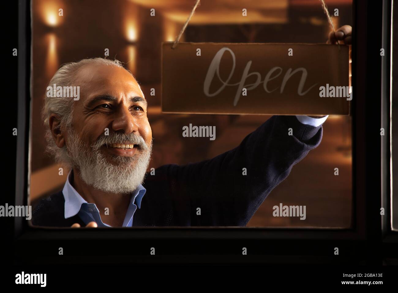 AN OLD MAN HOLDING OPEN SIGN BOARD Stock Photo - Alamy