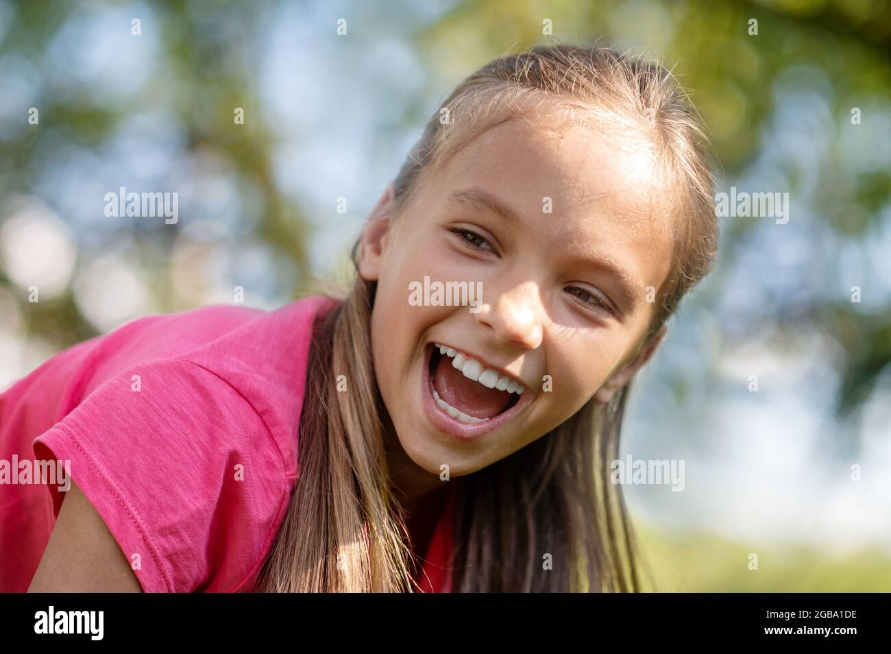 Face of enthusiastic pretty girl with toothy smile Stock Photo - Alamy