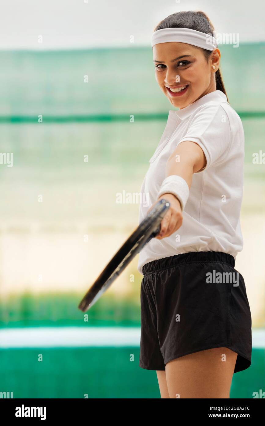 A CHEERFUL TENNIS PLAYER SHOWING RACKET IN FRONT OF CAMERA Stock Photo ...