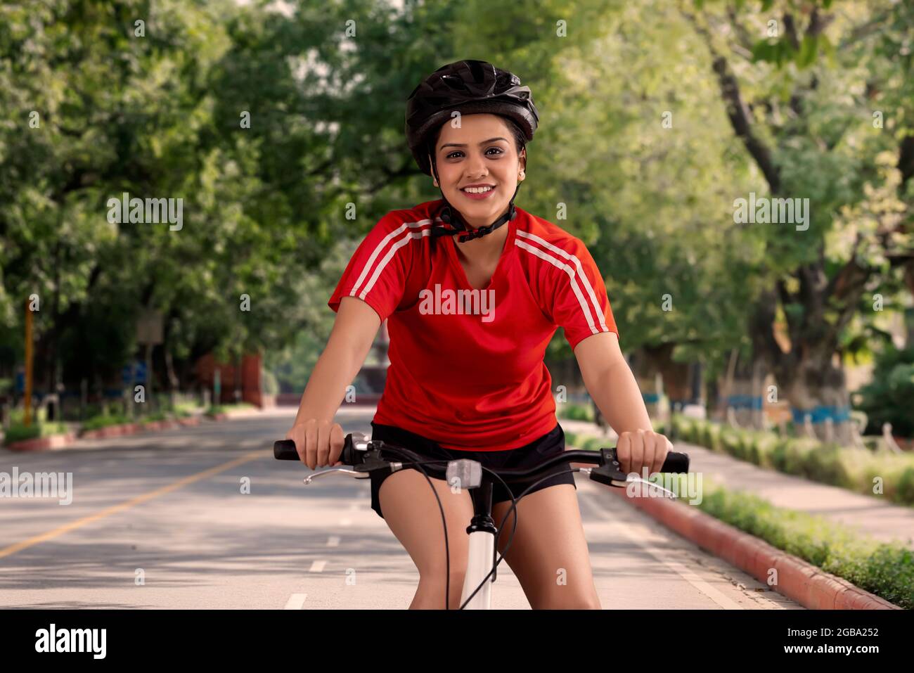 Woman riding a bicycle hi-res stock photography and images - Alamy