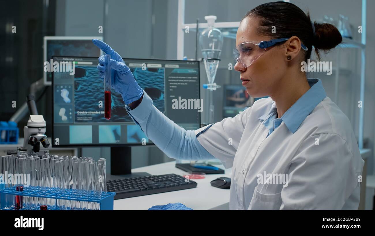 Doctor working in science laboratory with test tubes and chemical ...