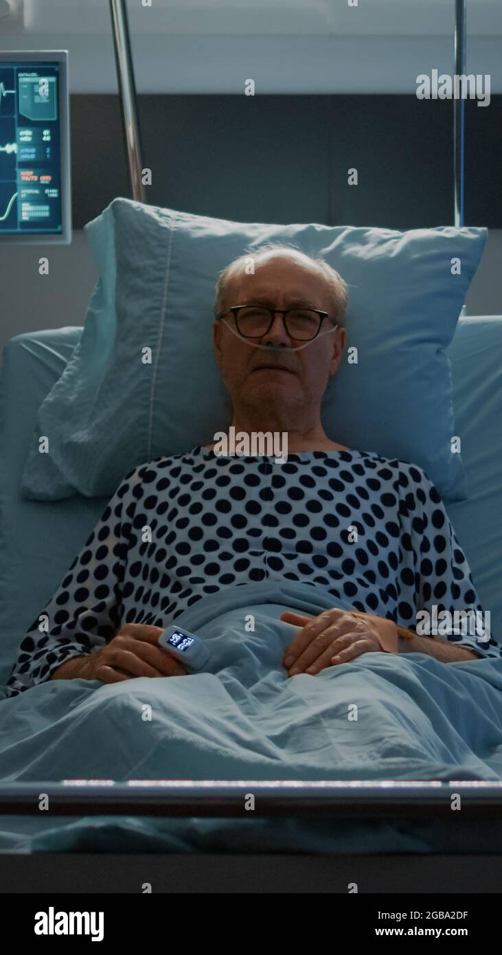 Patient with disease laying in hospital ward bed at clinic with modern ...