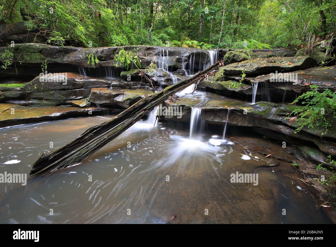 a large waterfall over some water Stock Photo - Alamy