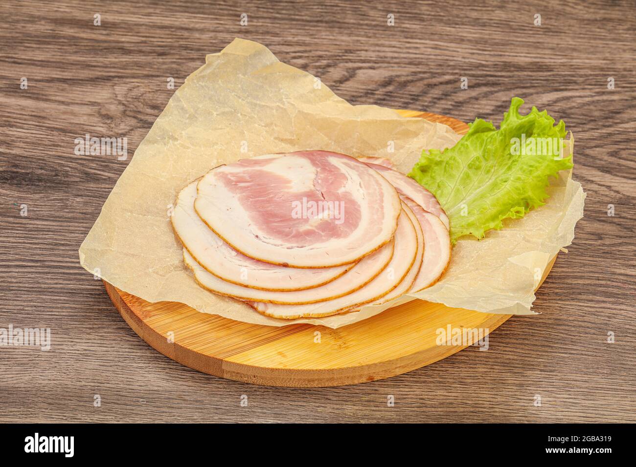 Sliced Italian Pancetta sausage over board Stock Photo - Alamy