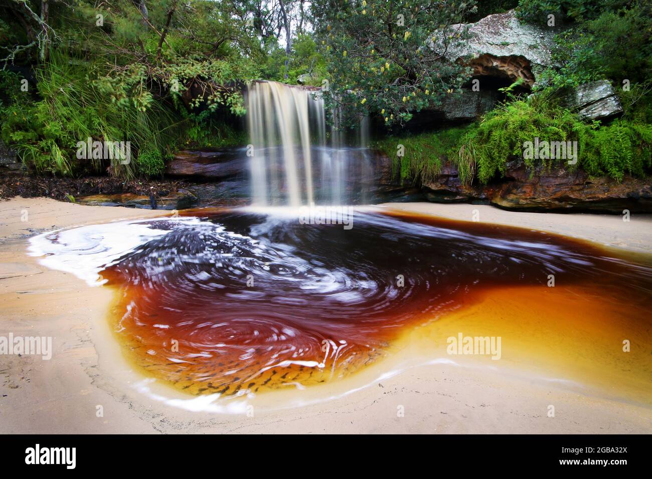 a large waterfall over a body of water Stock Photo - Alamy