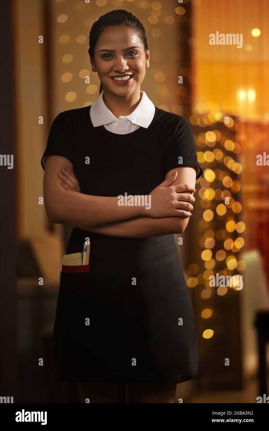 A CHEERFUL WAITRESS POSING IN FRONT OF CAMERA Stock Photo - Alamy