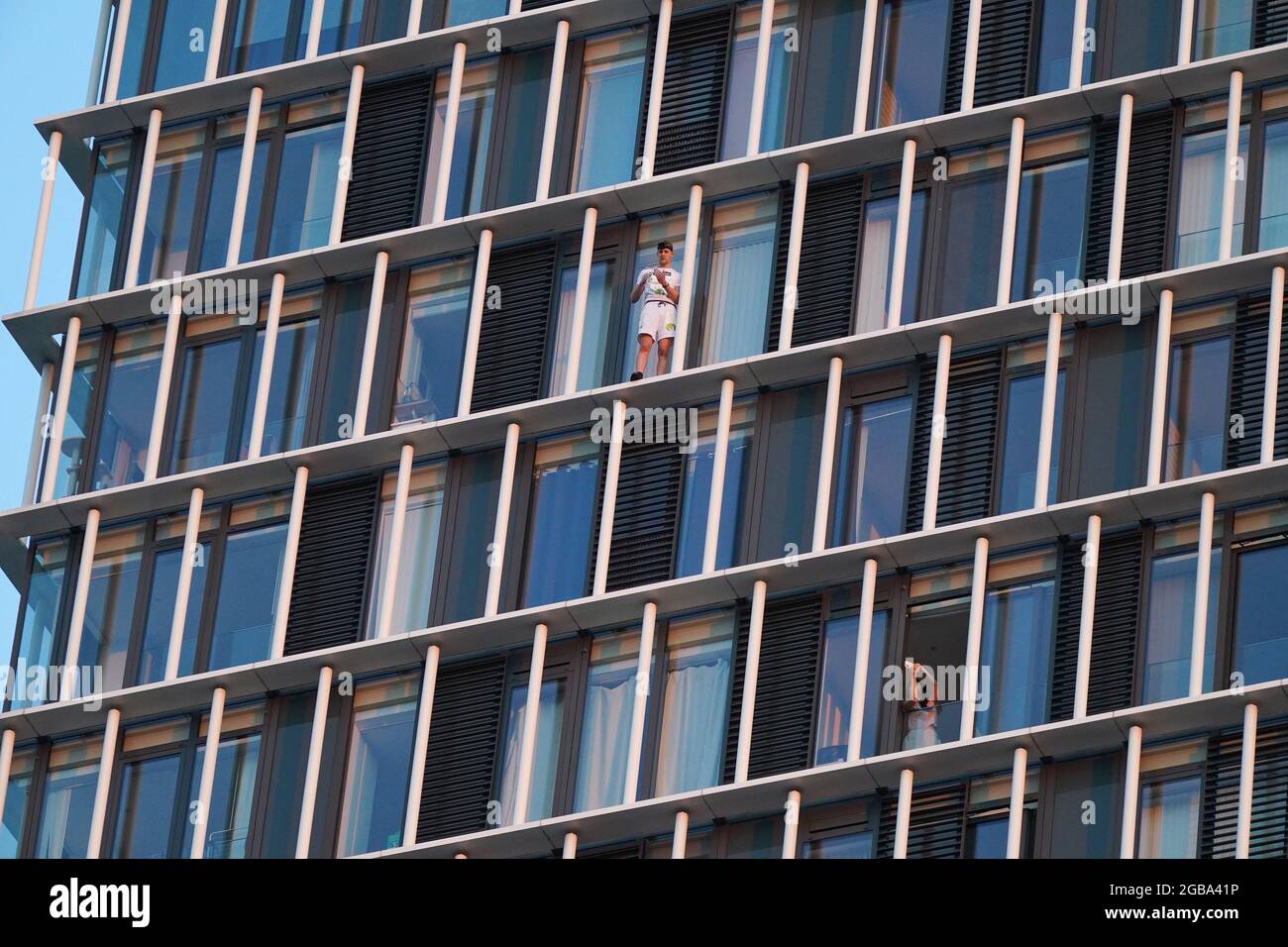 A woman takes a photo as free-solo climber George King pauses during an ...