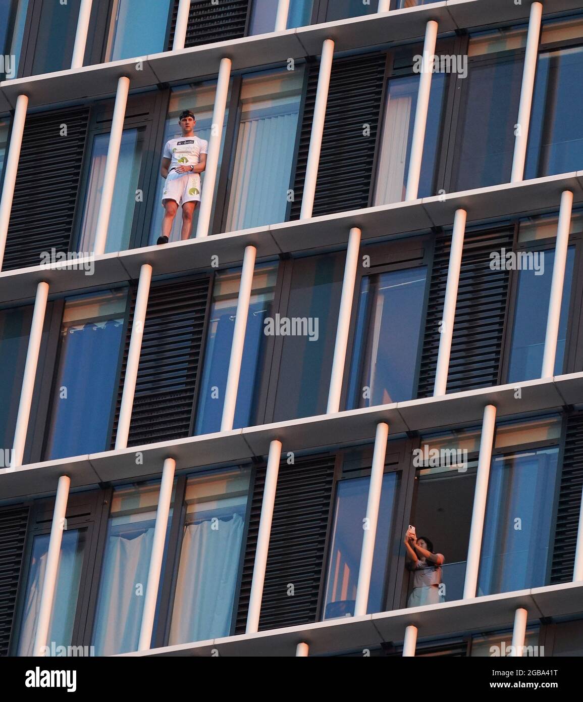 A woman takes a photo as free-solo climber George King pauses during an ...