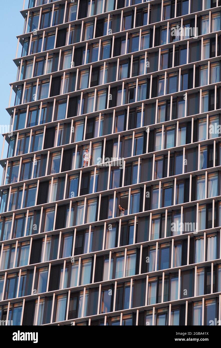 A woman takes a photo as free-solo climber George King pauses during an ...